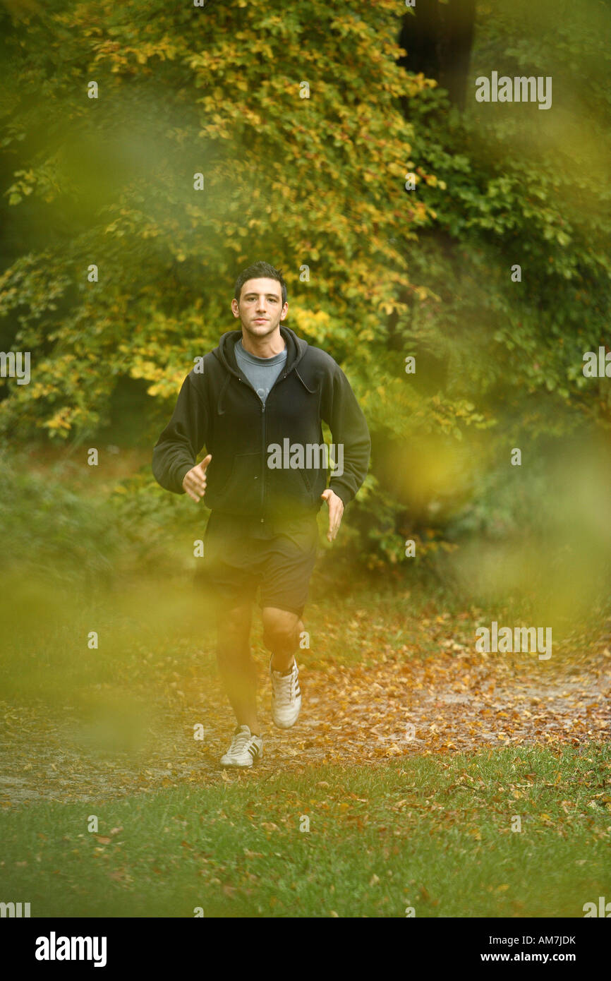 Young man jogging in the park Stock Photo - Alamy