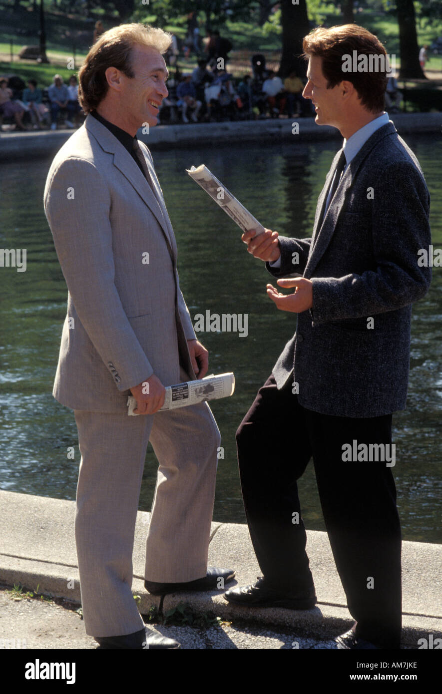 Businessmen conversing, smiling Stock Photo - Alamy