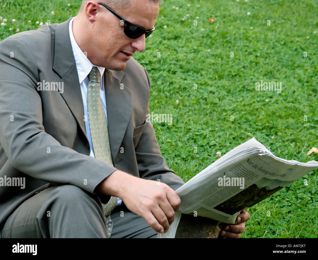Businessman reading a paper during lunch break Stock Photo - Alamy