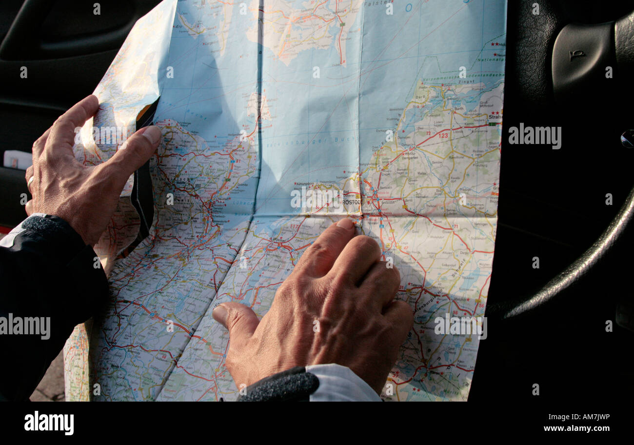 Searching for a destination the conventional way with a map, Germany ...