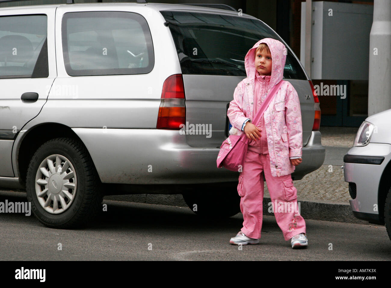 Child between parking cars crossing the street, Berlin, Germany Stock ...