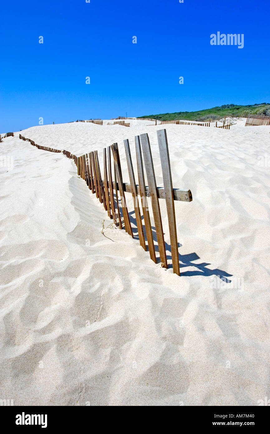 Old fence sticking out of deserted sandy beach dunes Stock Photo - Alamy