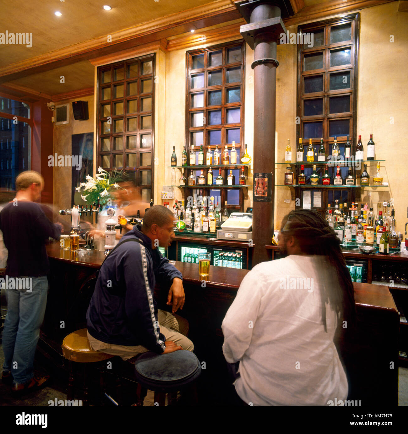 People socialising and drinking in pub bar Stock Photo - Alamy