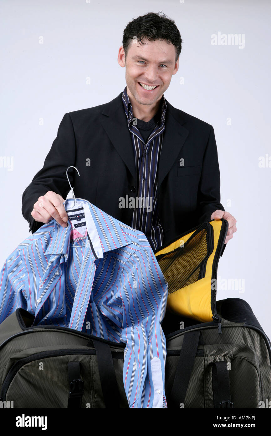 Man packing travelling bag Stock Photo - Alamy