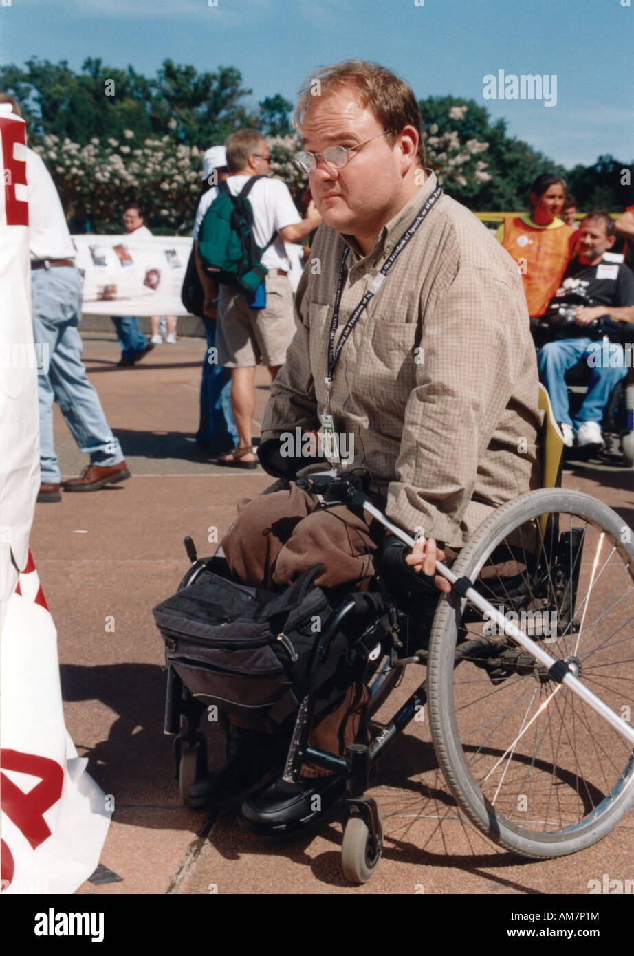 Man with a disability who utilizes a wheelchair for mobility attending ...