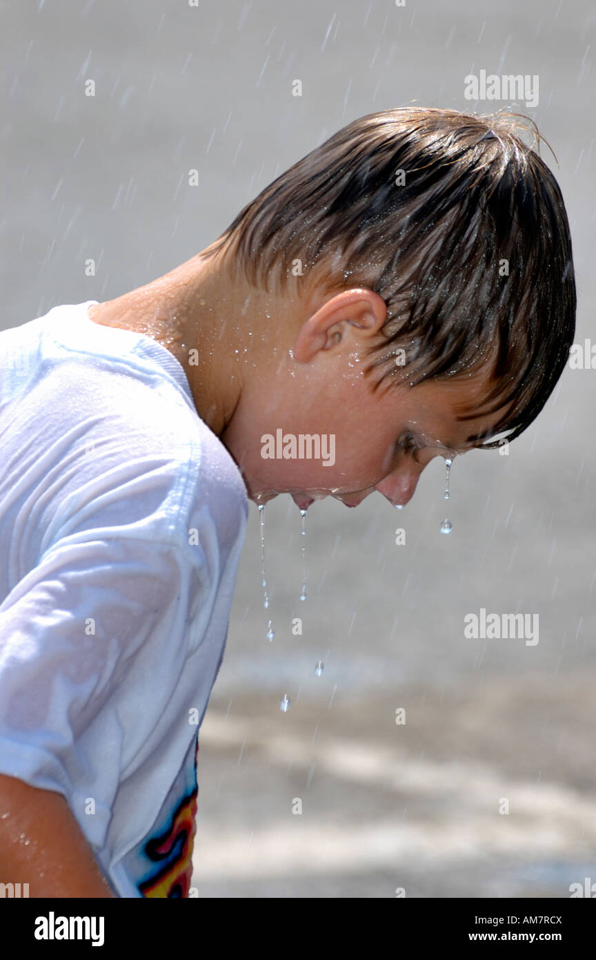 Boy Dripping Water After Being Sprayed by a Fire Hose Stock Photo - Alamy