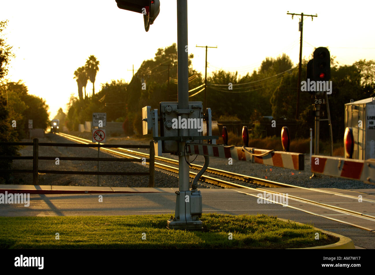 Metrolink passenger train approaching railroad crossing with lights on ...