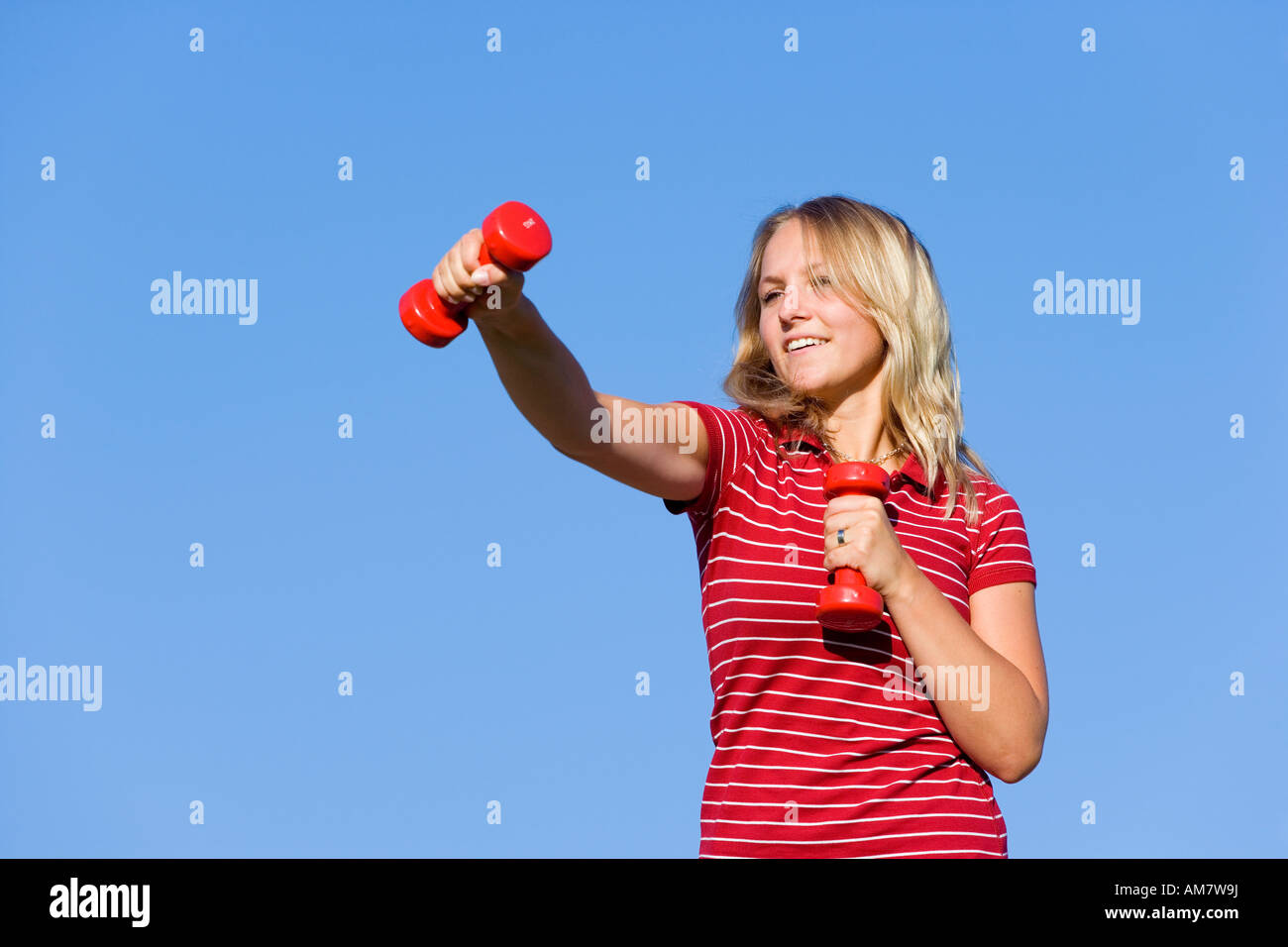 A young woman, 20 years old, training with barbells Stock Photo - Alamy