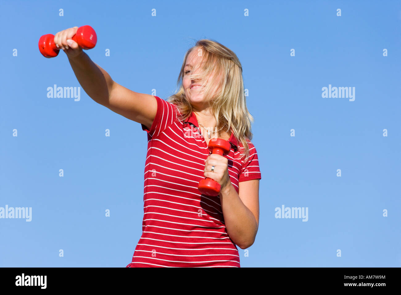 A young woman, 20 years old, training with barbells Stock Photo - Alamy