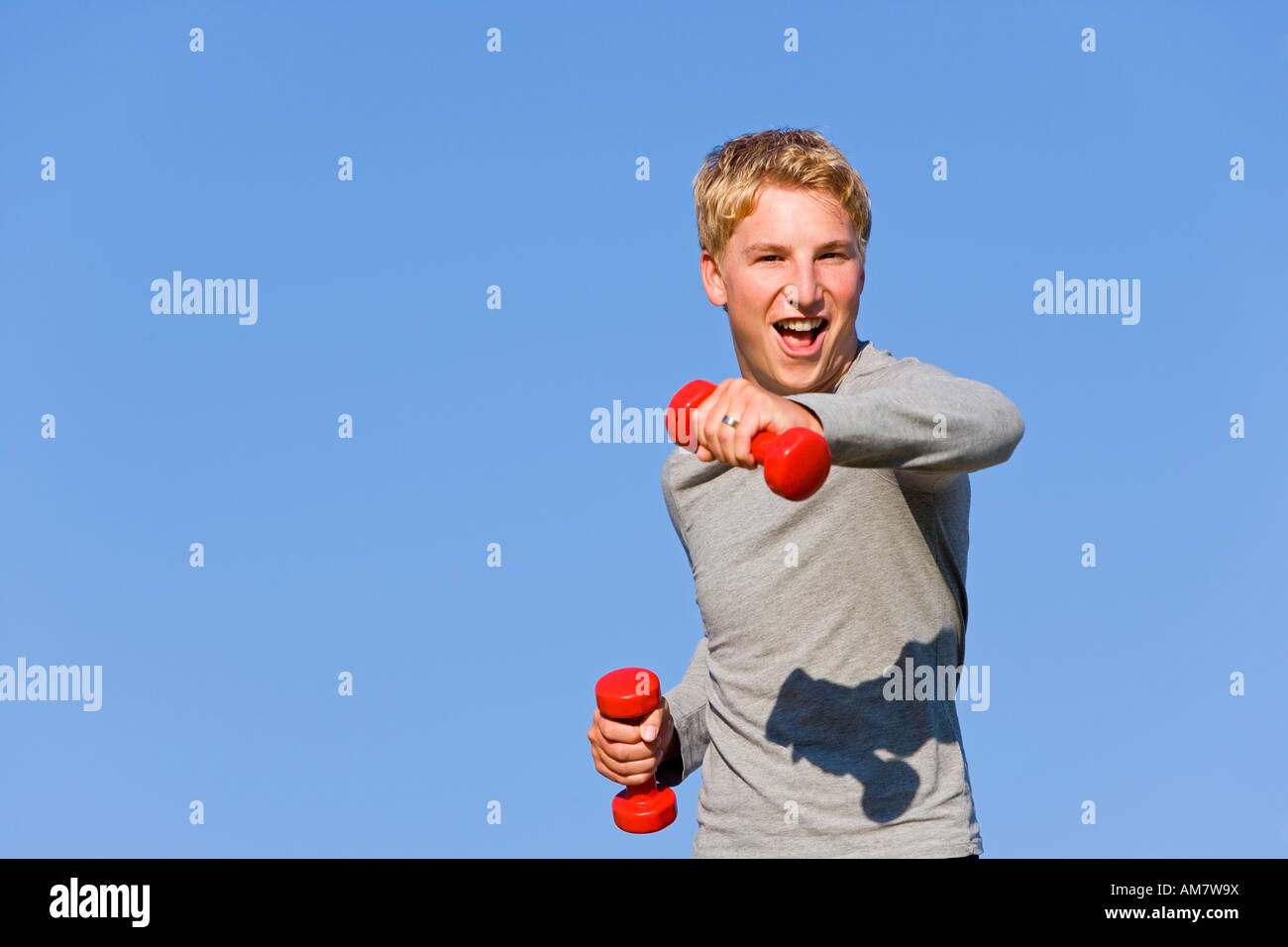 A young man, 22 years old, training with barbells Stock Photo - Alamy