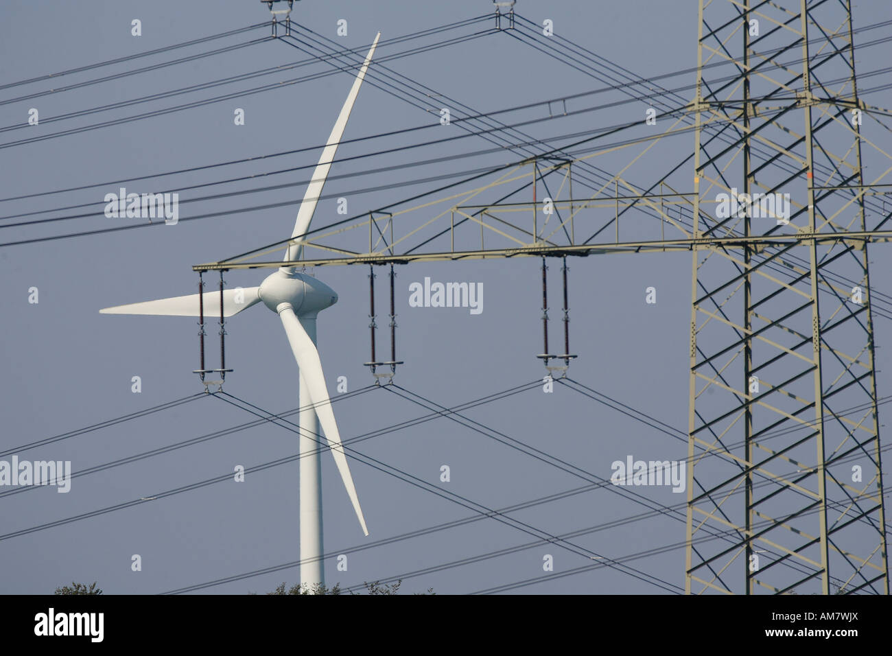 Wind energy plant and a pylon Stock Photo - Alamy