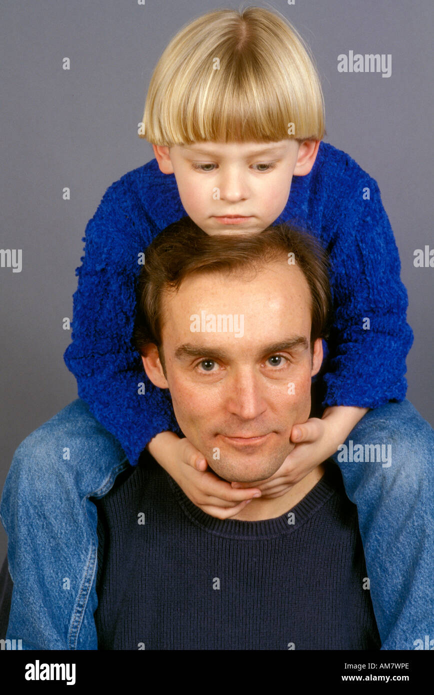 Son sitting on father's shoulders, portrait Stock Photo - Alamy