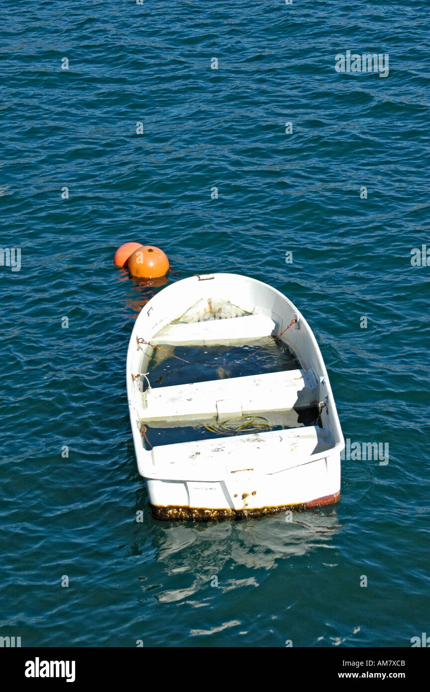 Row boat about to sink in the Pacific ocean at Port San Luis in ...