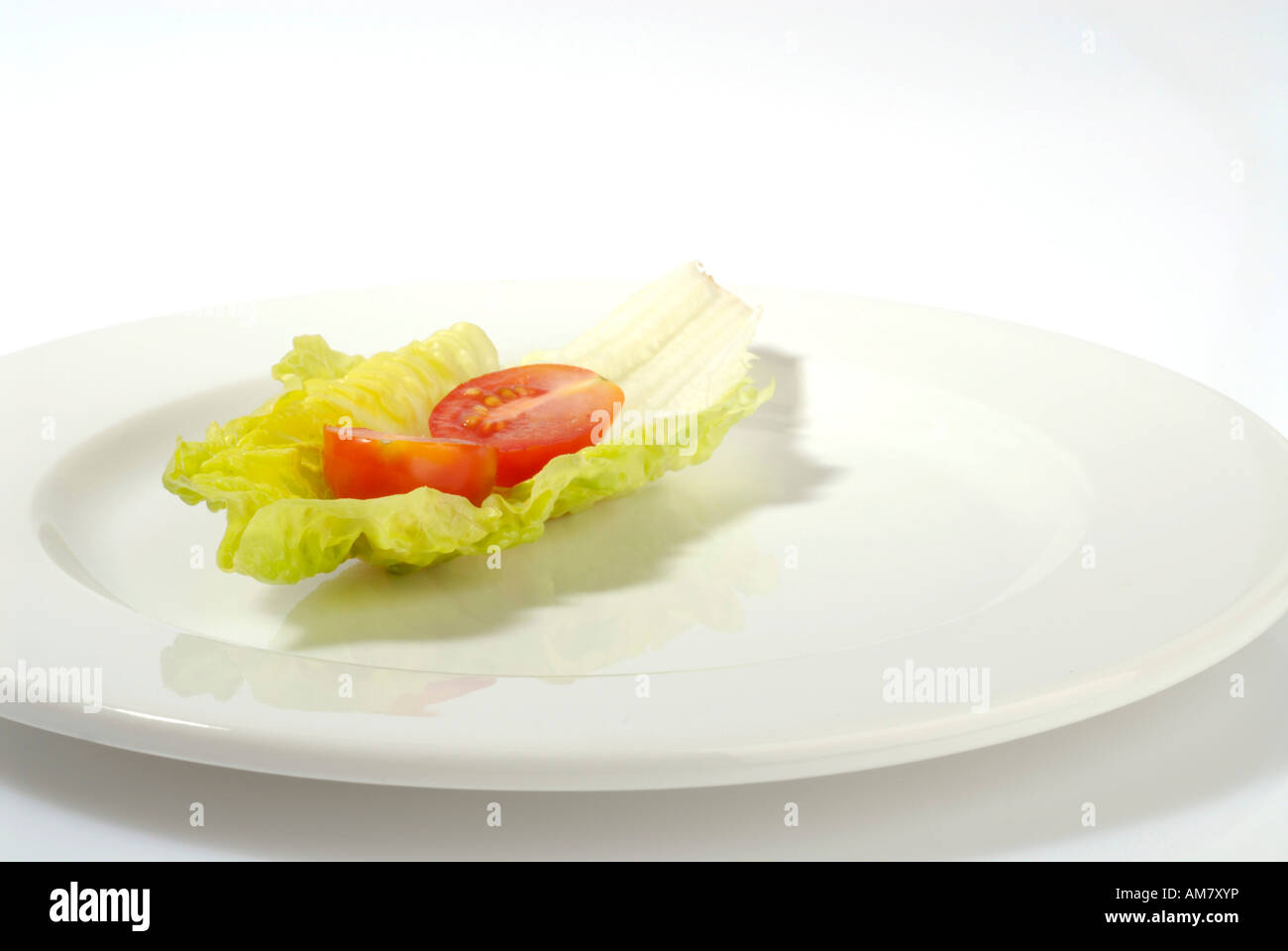 Lettuce leaf and tomato on a plate Stock Photo - Alamy