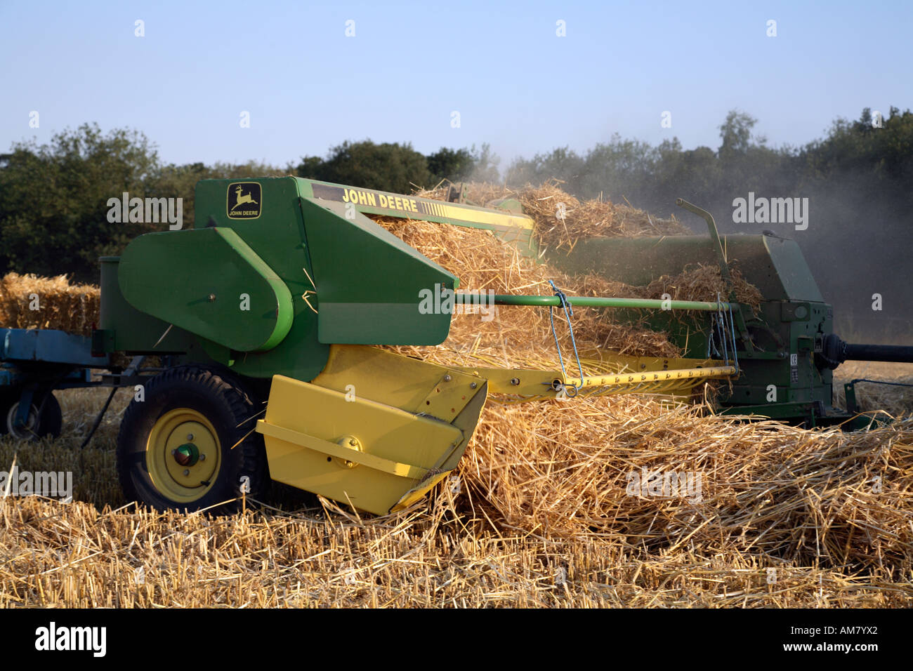 Close up of baling machine baling straw 1 Stock Photo - Alamy