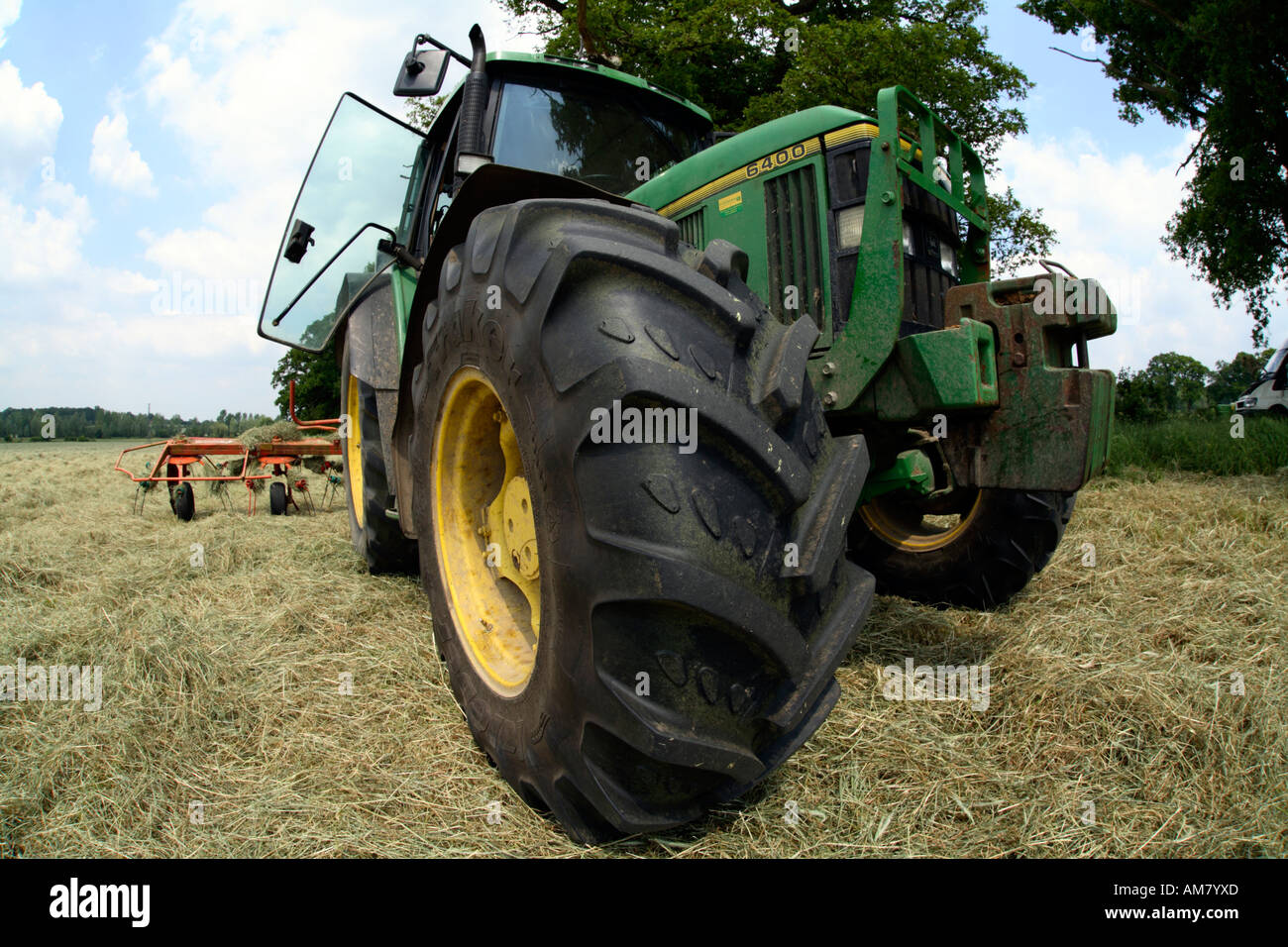 Wide angle front view of tractor with tedder attached 1 Stock Photo - Alamy