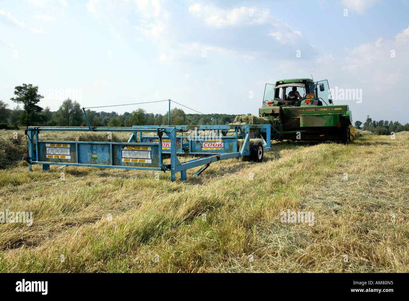 Farmer baling summer hay 4 Stock Photo - Alamy