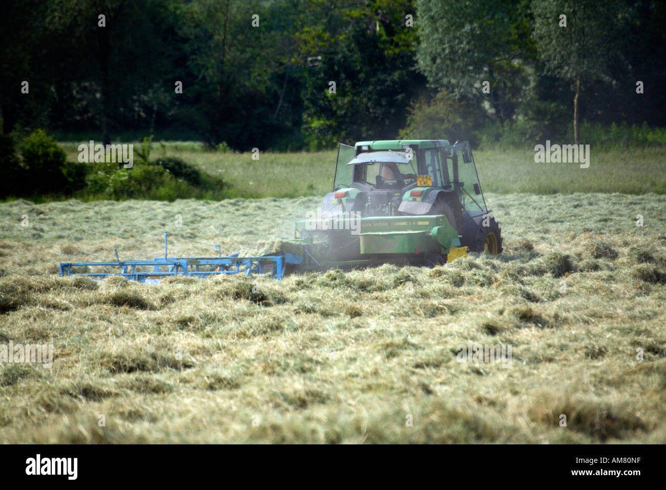 Farmer baling summer hay 5 Stock Photo - Alamy