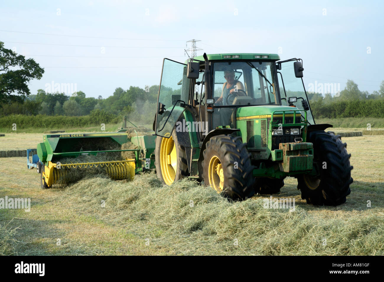 Farmer baling summer hay 17 Stock Photo - Alamy