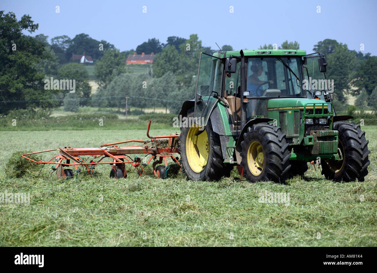 Female farm worker in tractor turning hay in summer 7 Stock Photo - Alamy