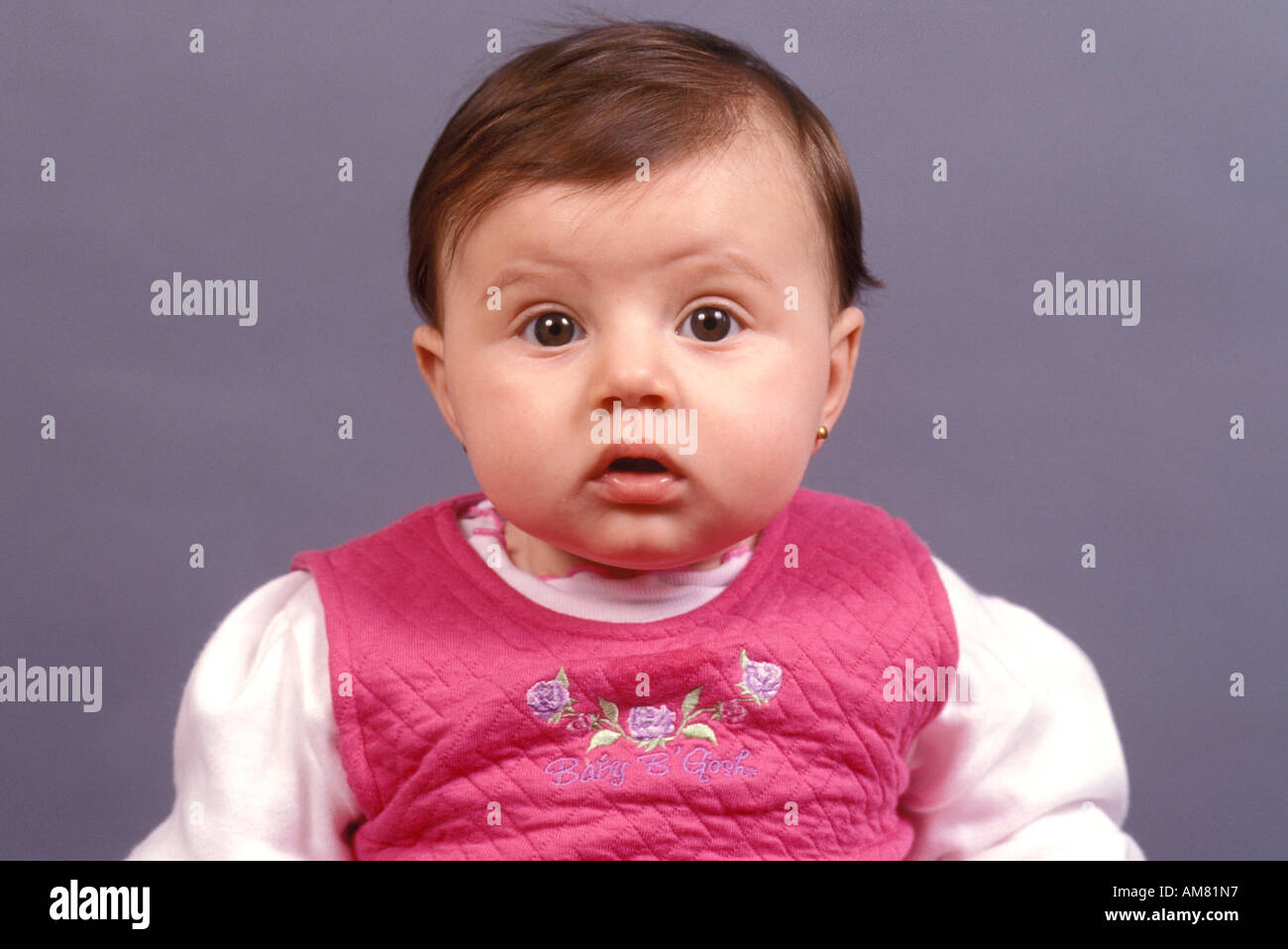 Baby girl (15-18 months), staring Stock Photo - Alamy
