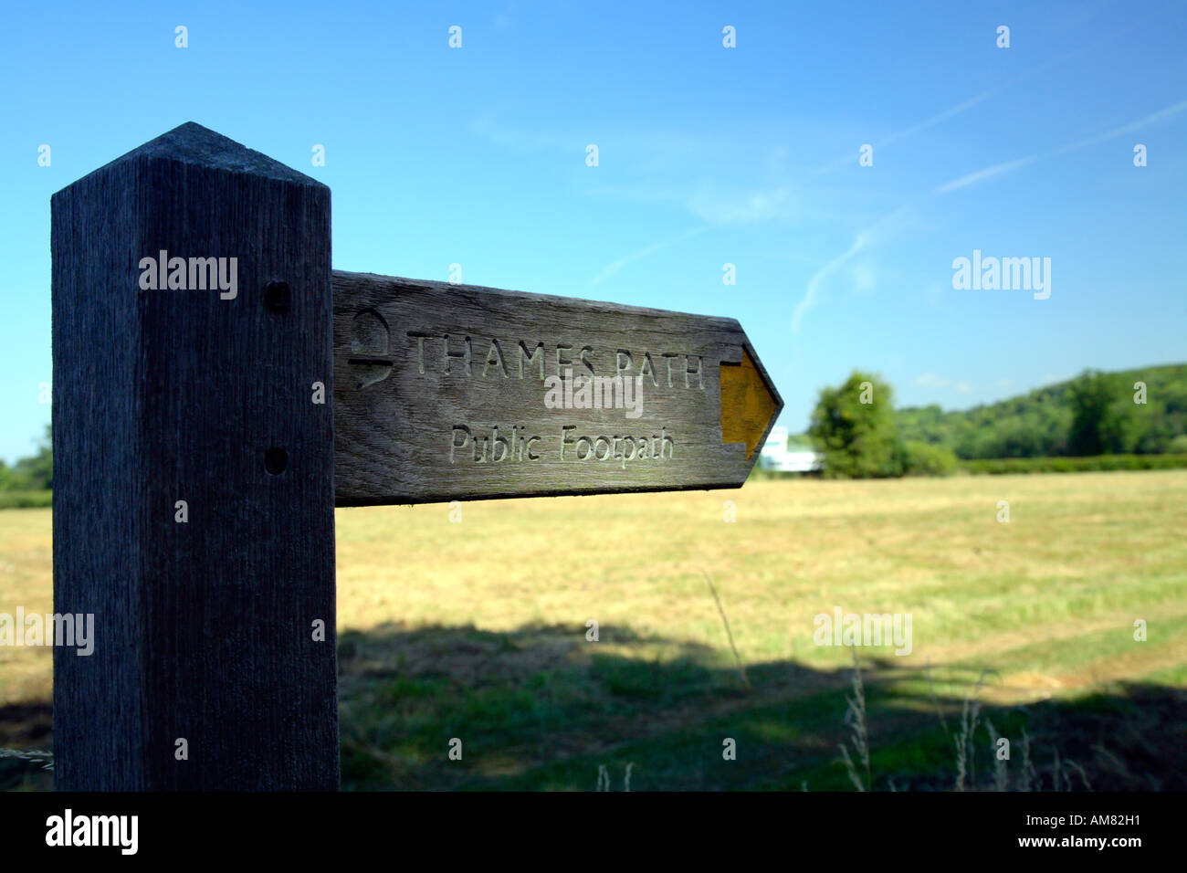 Thames path wooden directional signpost along rural section of Thames ...