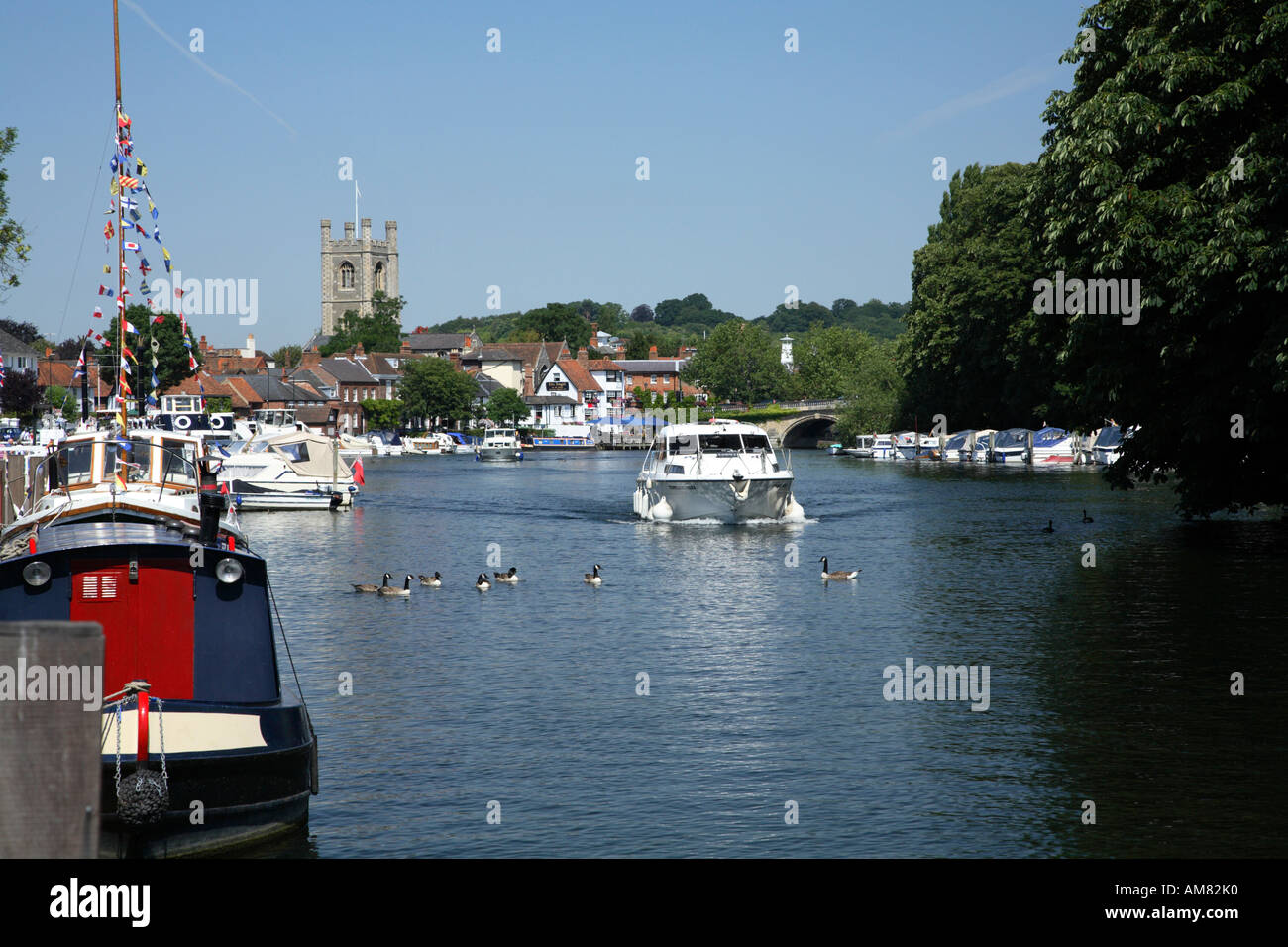 Thameside view of Henley on Thames on hot sunny summer day with moored ...