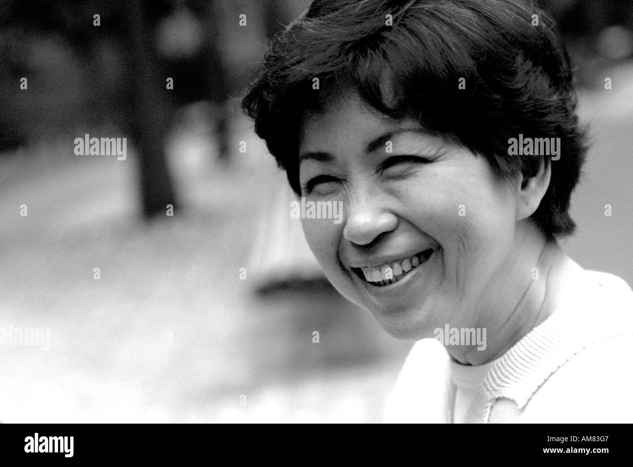Mature woman smiling, side view Stock Photo - Alamy