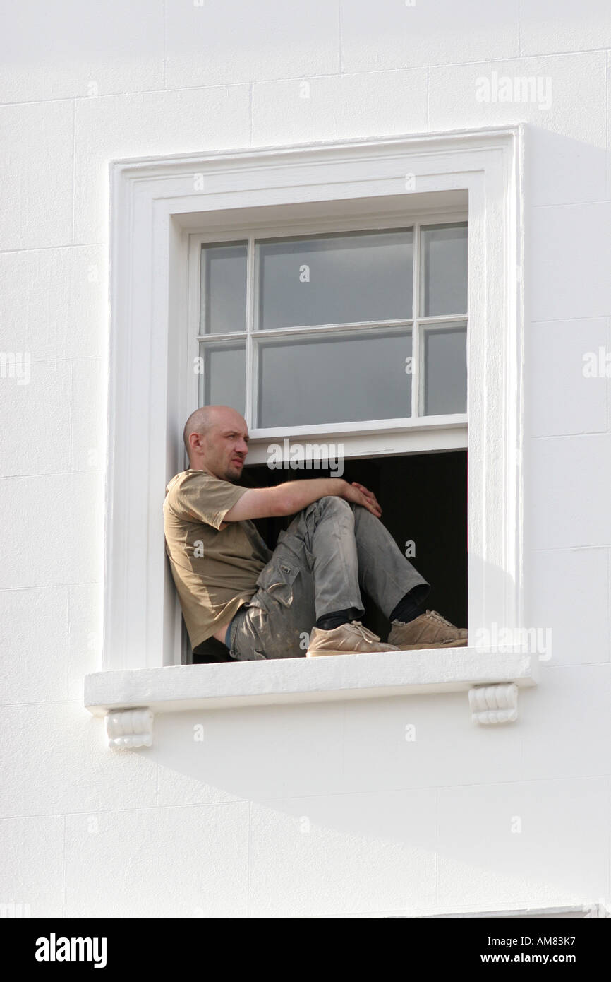 Man sitting in a window Stock Photo - Alamy