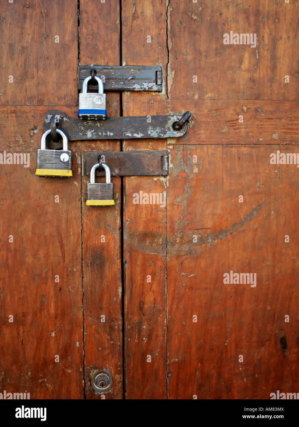 Three locks on an old door Stock Photo - Alamy