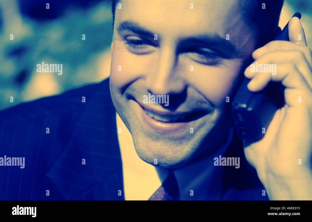 Smiling man using cellphone hi-res stock photography and images - Alamy