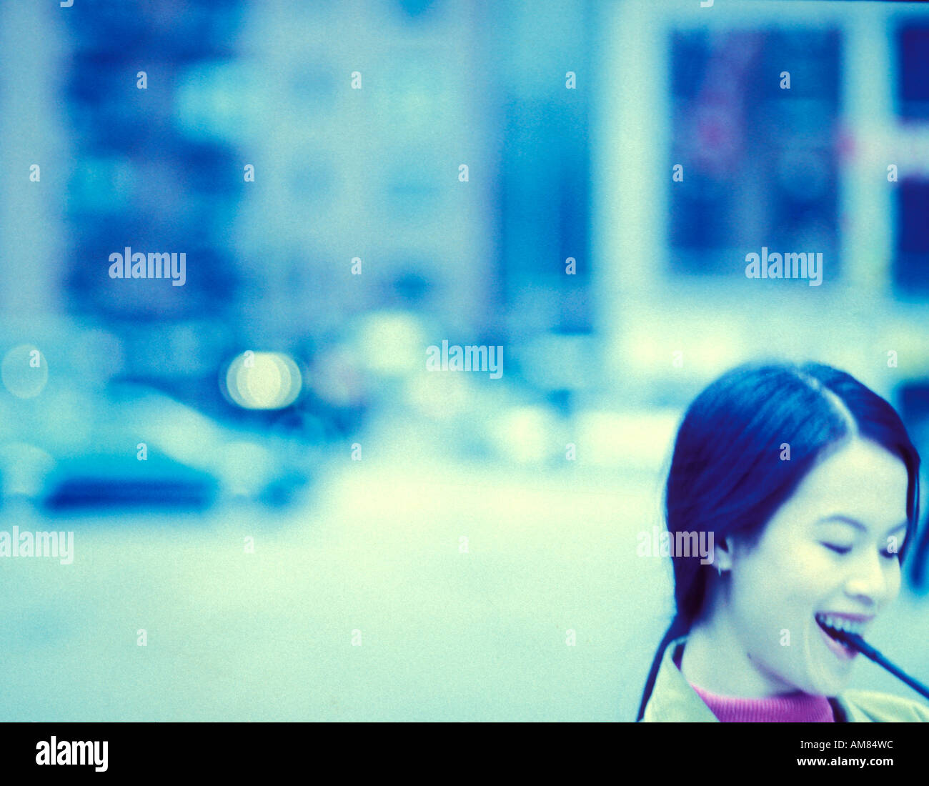 Young woman biting pen hi-res stock photography and images - Alamy