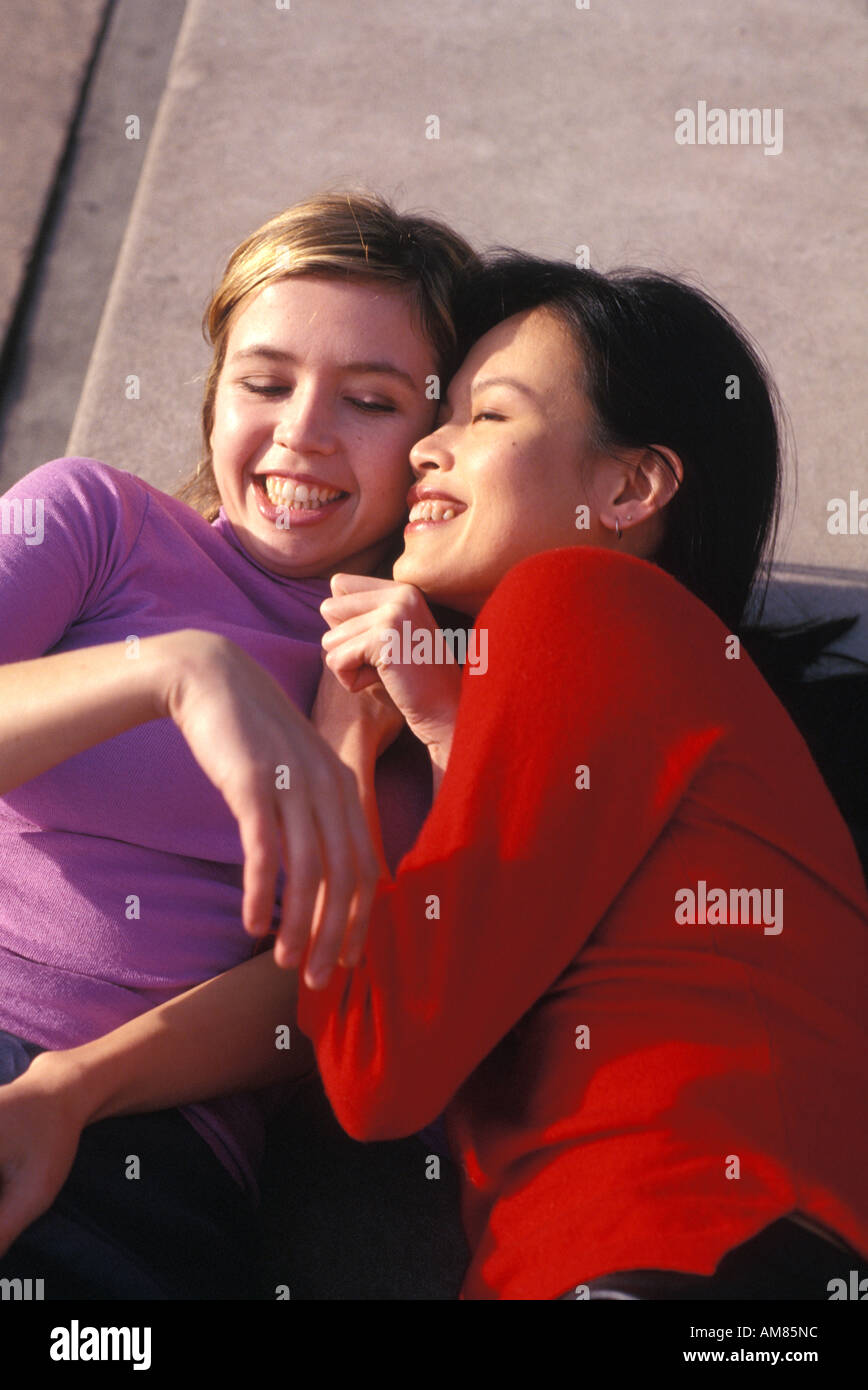 Young women hugging, smiling Stock Photo - Alamy