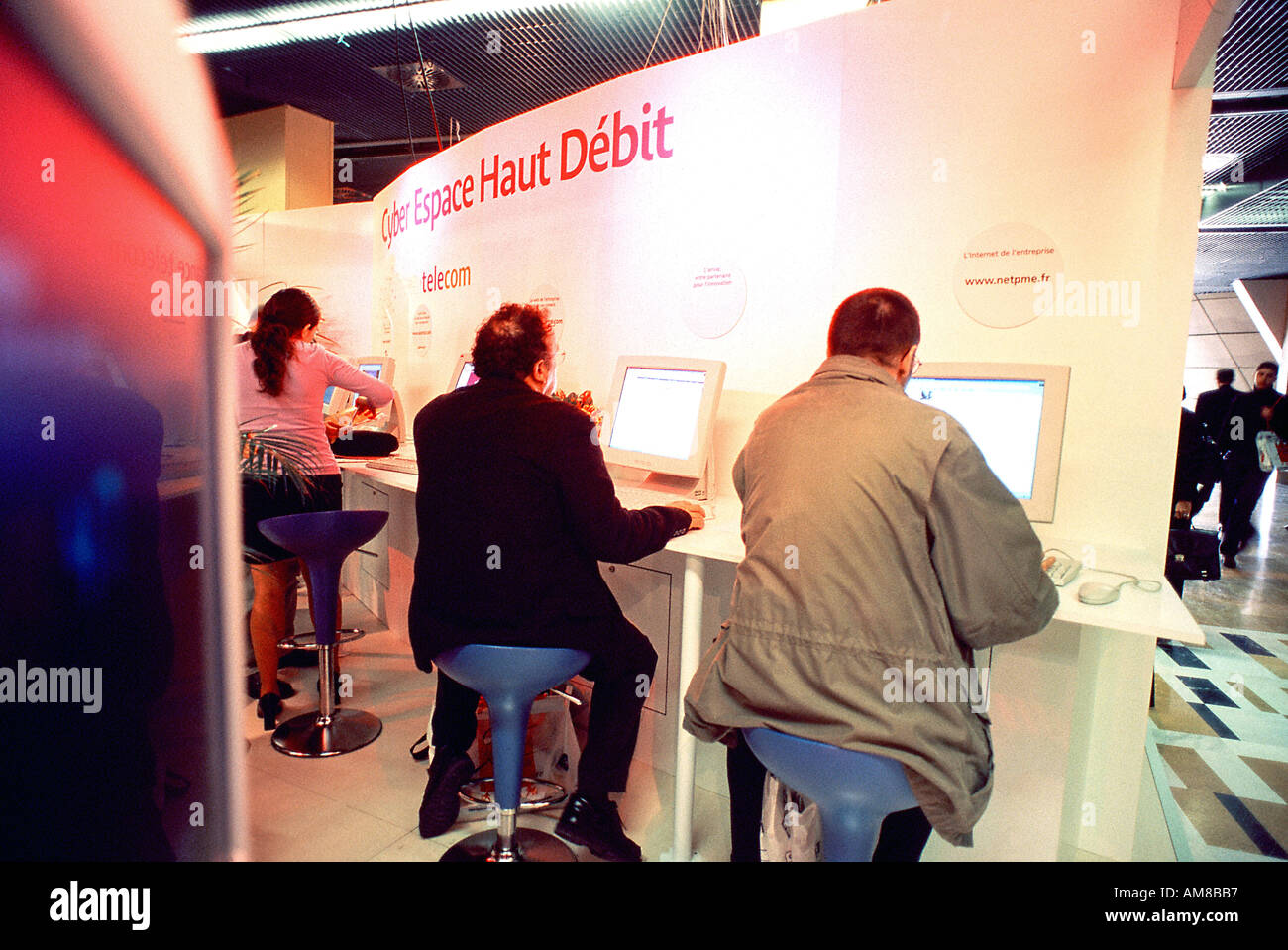 Businessmen at Convention Exhibit Using "High Speed ADSL" Access to ...