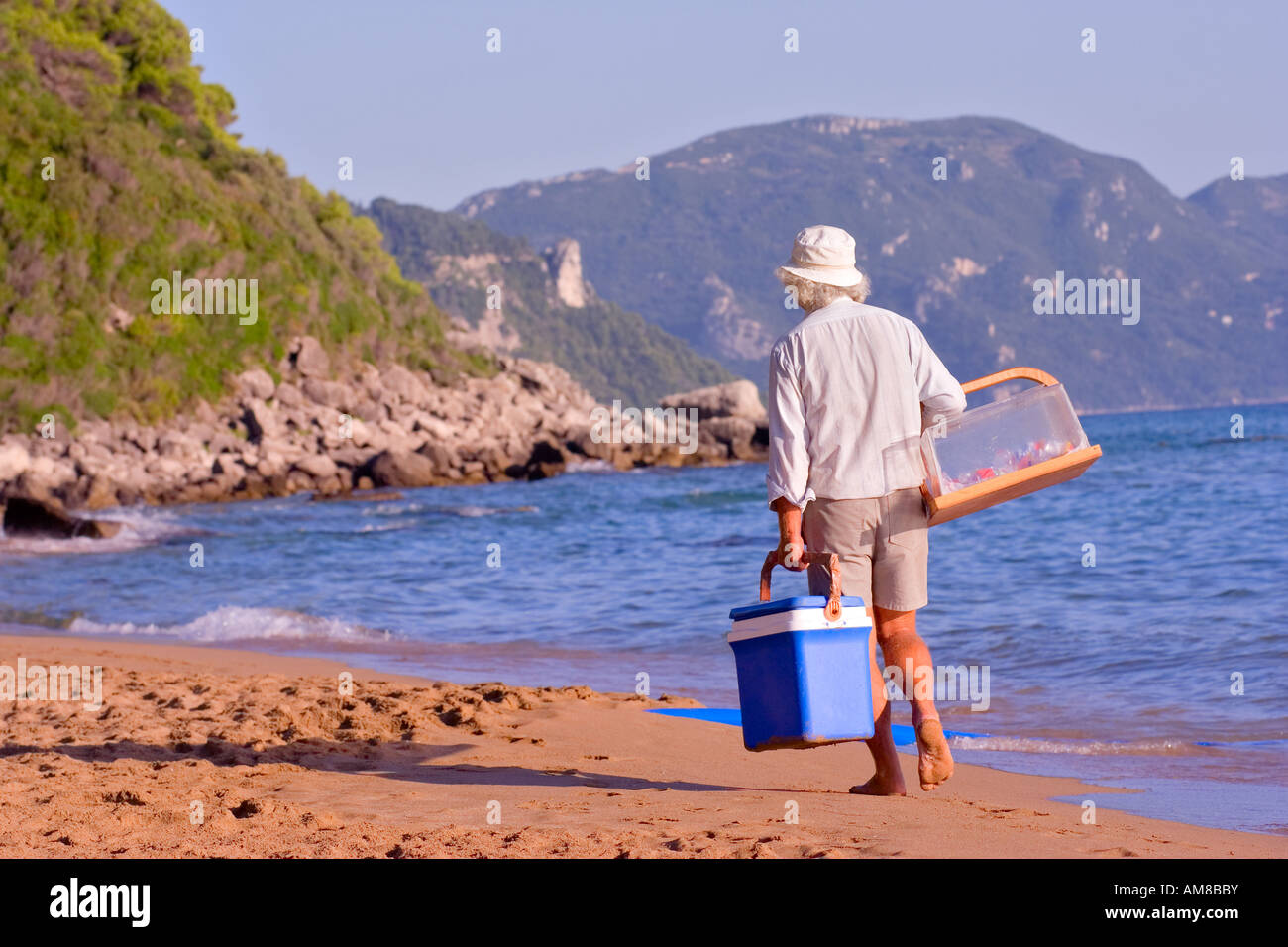 Beach vendor walking at the beach on Corfu island Greece Stock Photo ...