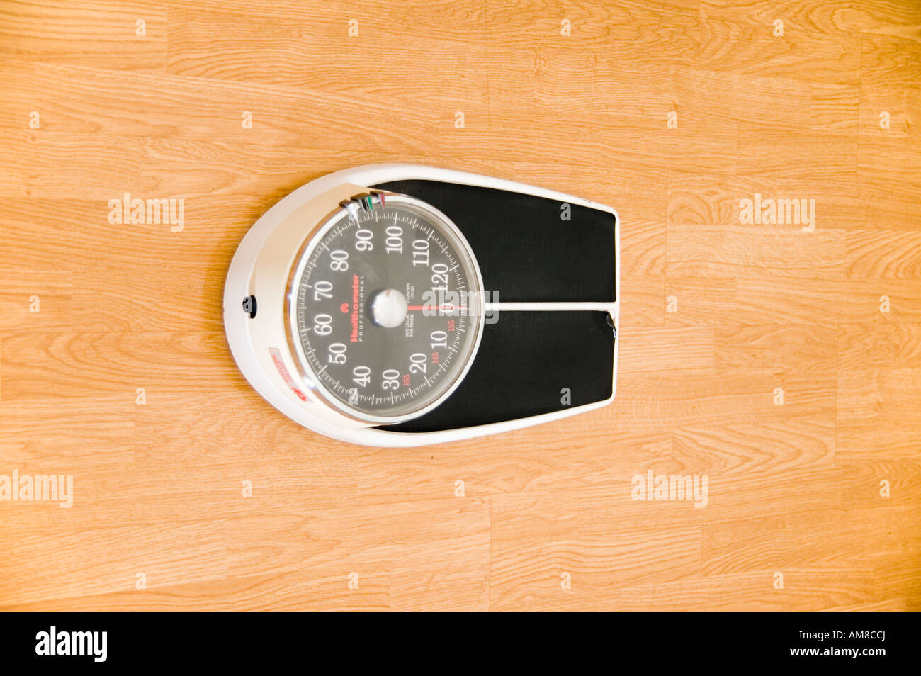 A scale on a wooden floor Stock Photo - Alamy