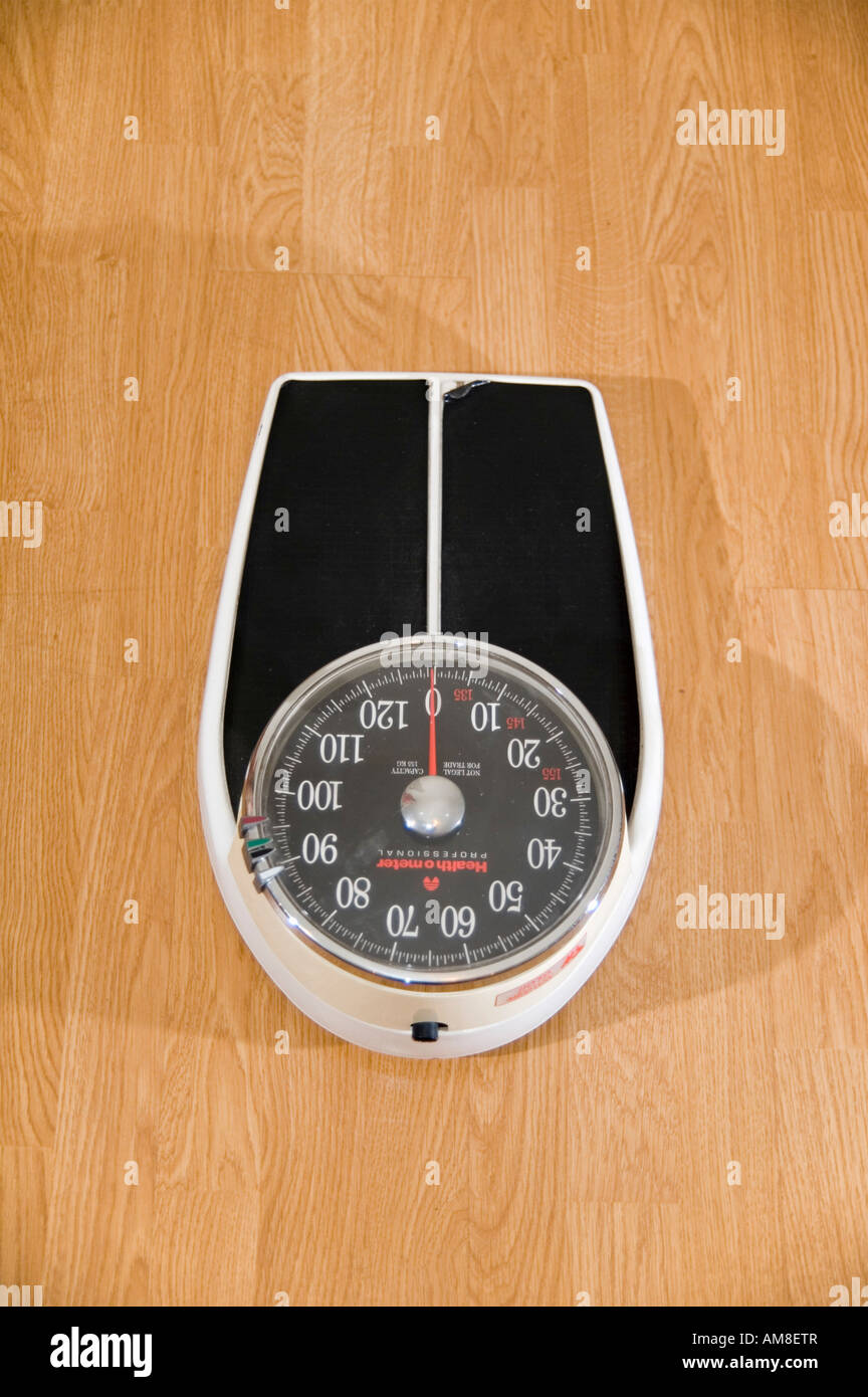 A scale on a wooden floor Stock Photo - Alamy
