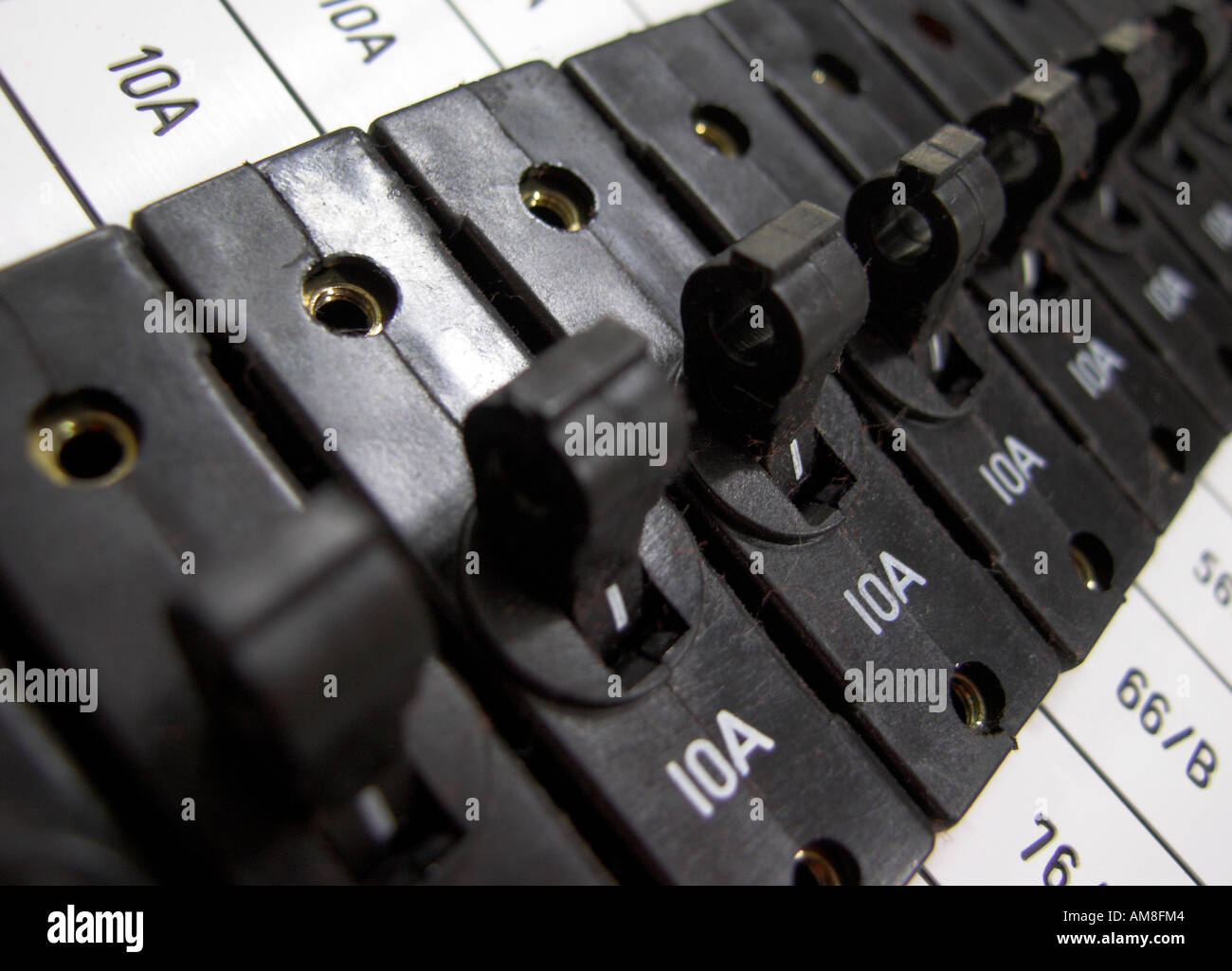 A close up abstract image of a row of industrial electrical switches ...