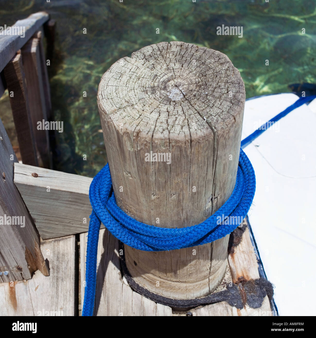 Rope tied around wood dock pier on the Island of Roatan, Honduras Stock ...