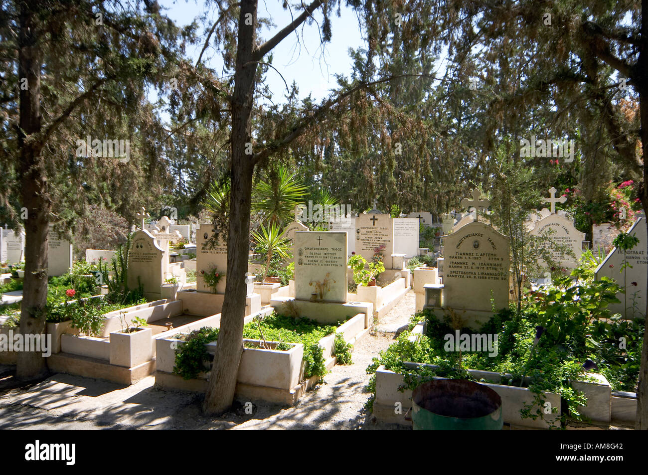 Graves tombstones and green vegetation in Greek Orthodox cemetry or ...