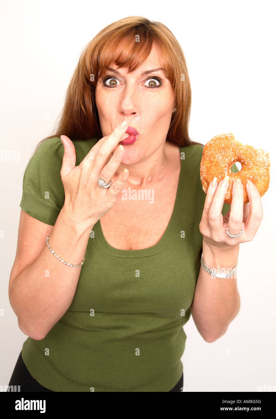 Cut out of an mischevious woman licking the sugar off her finger while ...