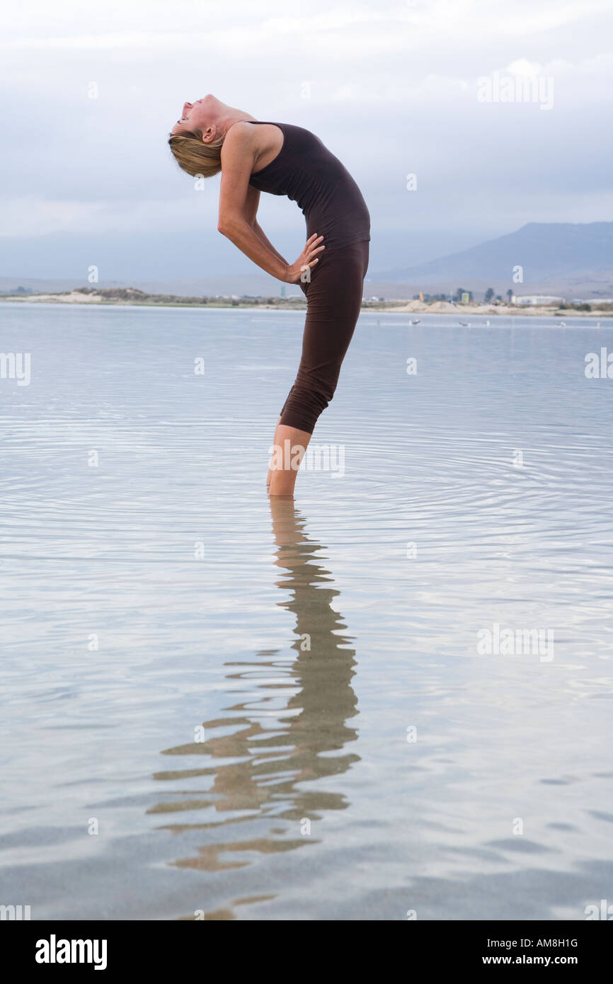 young woman doing a back arch yoga pose in nature Stock Photo - Alamy
