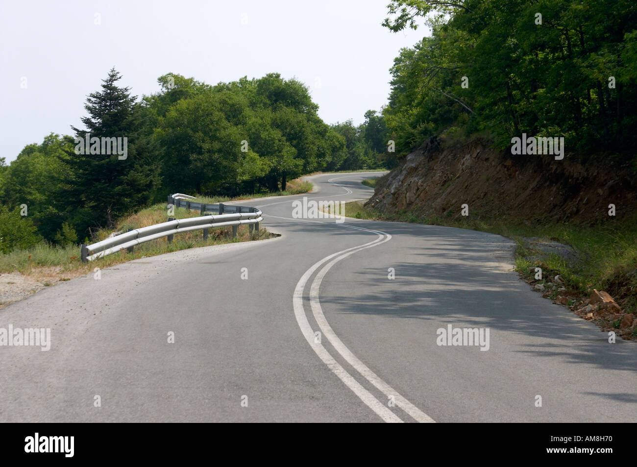 Curved winding road receding into distance Olympus region Greece Stock ...
