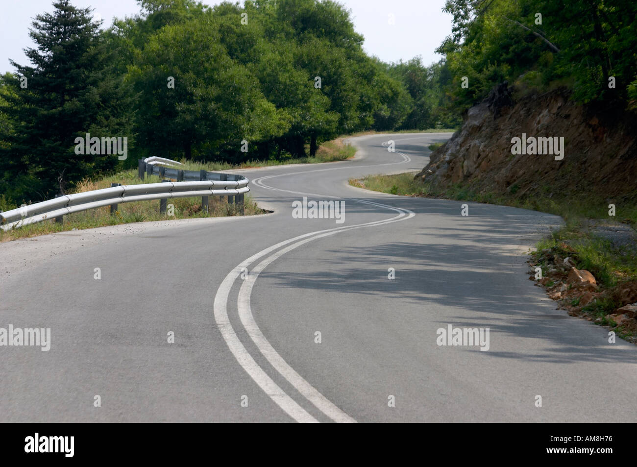 Curved winding road receding into distance Olympus region Greece Stock ...