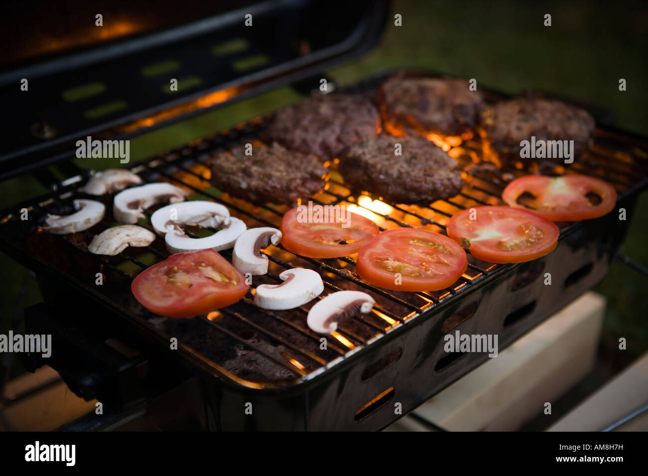 cooking with a portable gas barbecue Stock Photo - Alamy
