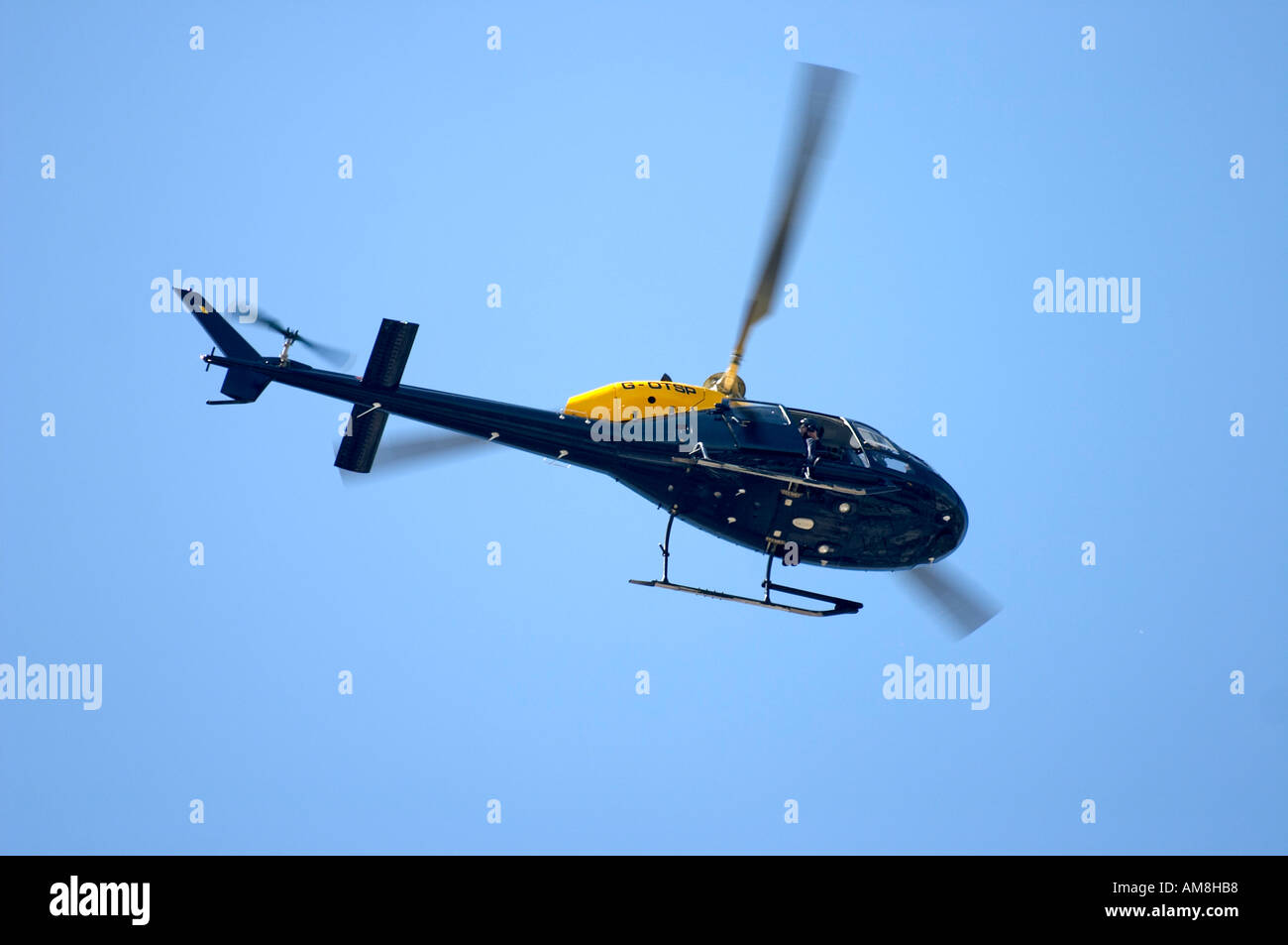 Helicopter flying from underneath Stock Photo - Alamy