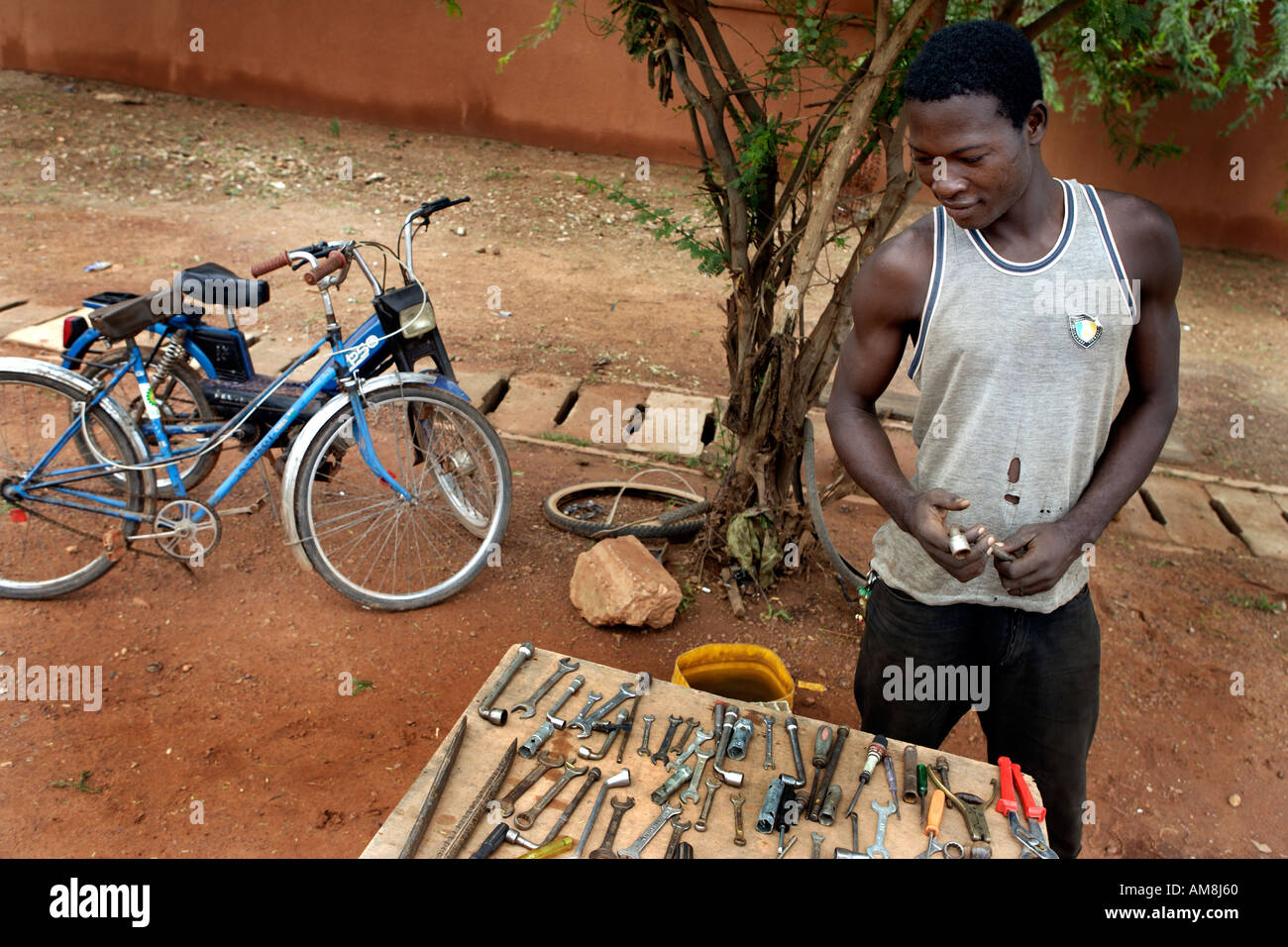A road side mobylette mechanic with all his tools laid out neatly on a ...