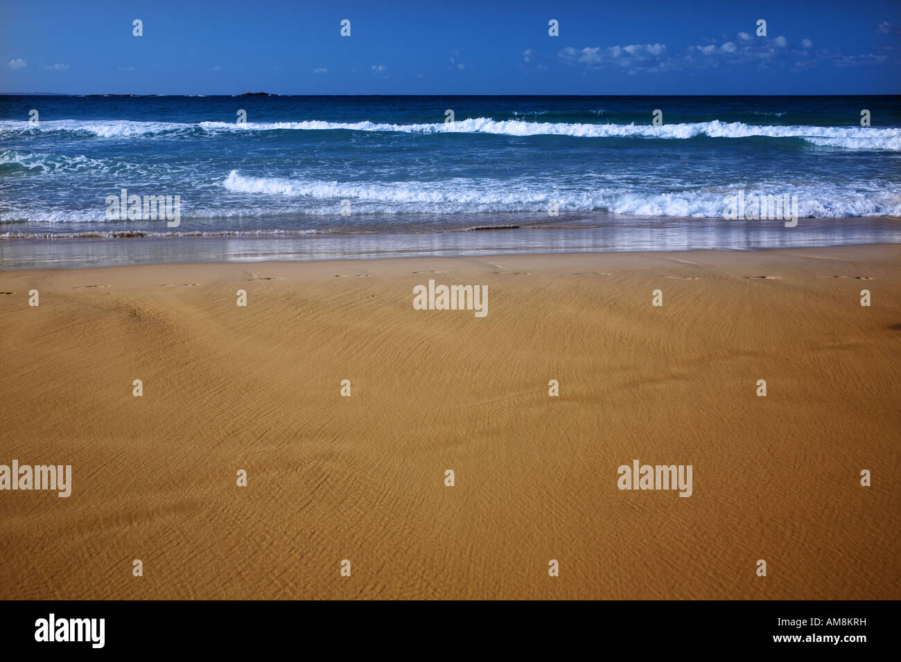 Tide coming onto a golden sandy beach Australia Stock Photo - Alamy