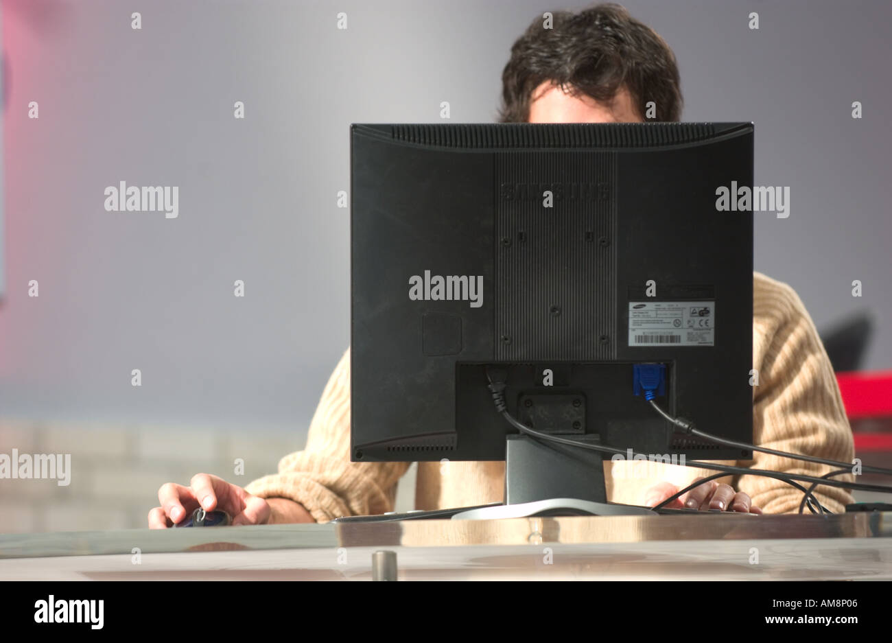 man behind flat-screen computer monitor Stock Photo - Alamy