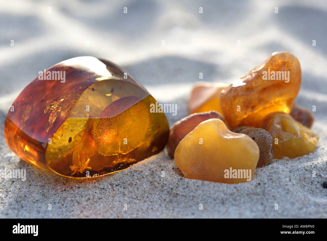 Amber stone, polished and unpolished (right Stock Photo - Alamy
